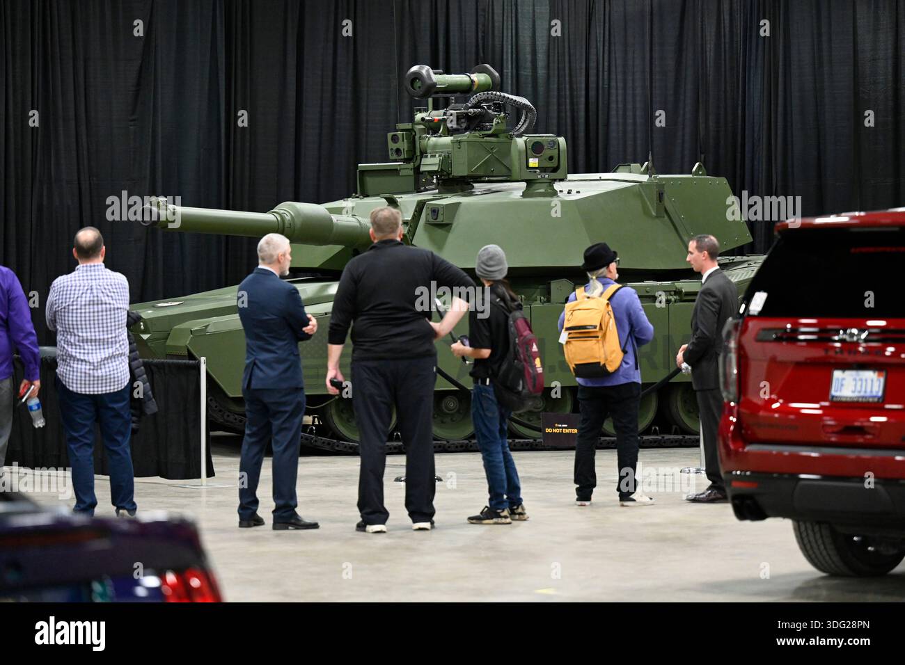 Members of the media look over a U.S. Army display of a prototype of ...