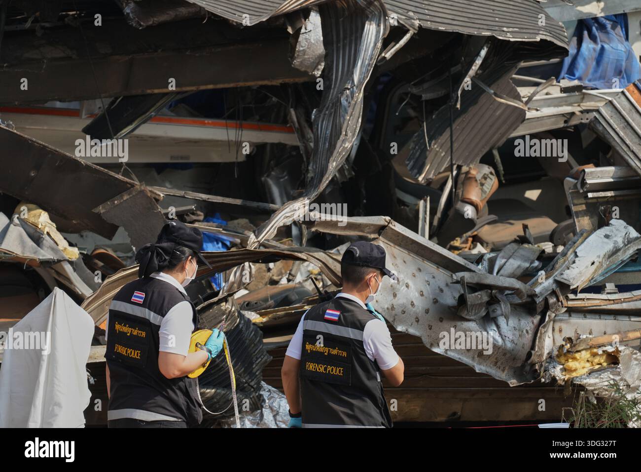 Forensic police workers inspect the site of a train accident, a day ...