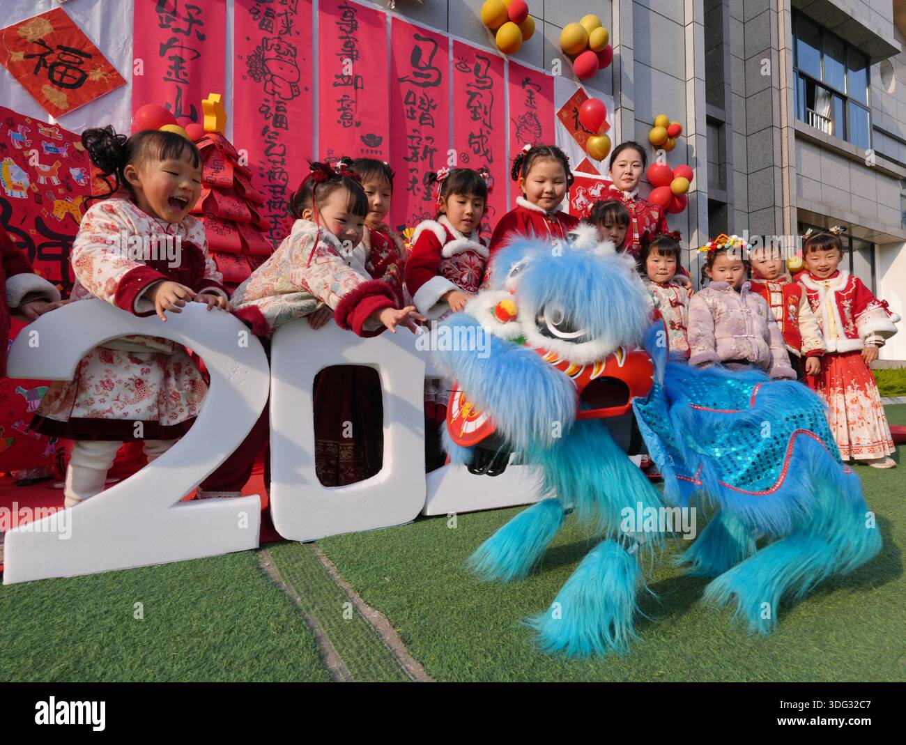 Children interact with a quadruped robot dressed as a traditional ...