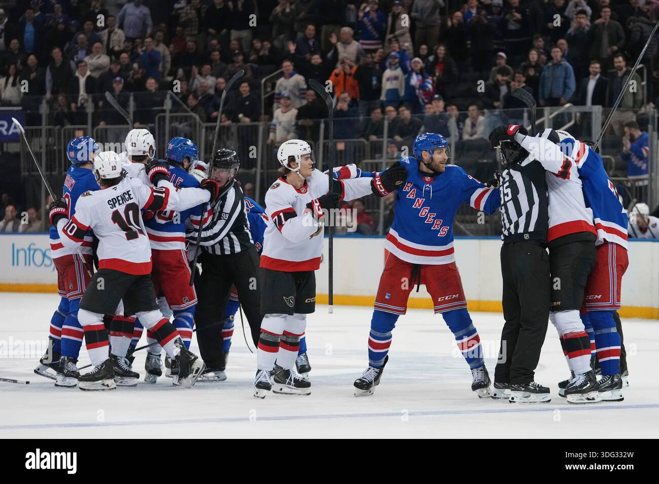 Officials work to separate players during the third period of an NHL ...