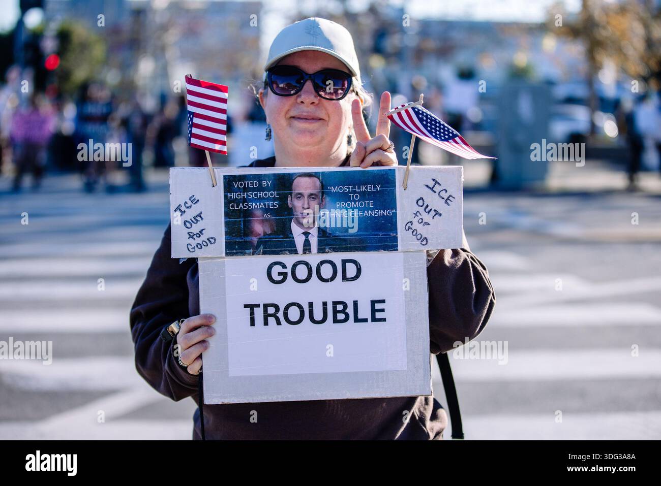 A protester displays a sign reading “GOOD TROUBLE,” with handwritten ...