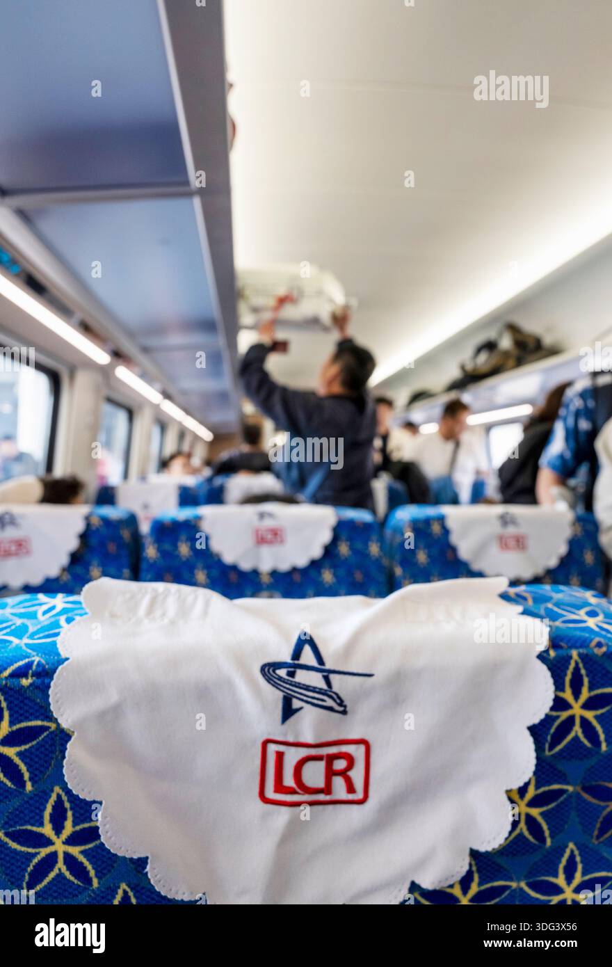 Laos-January 11 2026:Passengers aboard the high speed train sort their ...