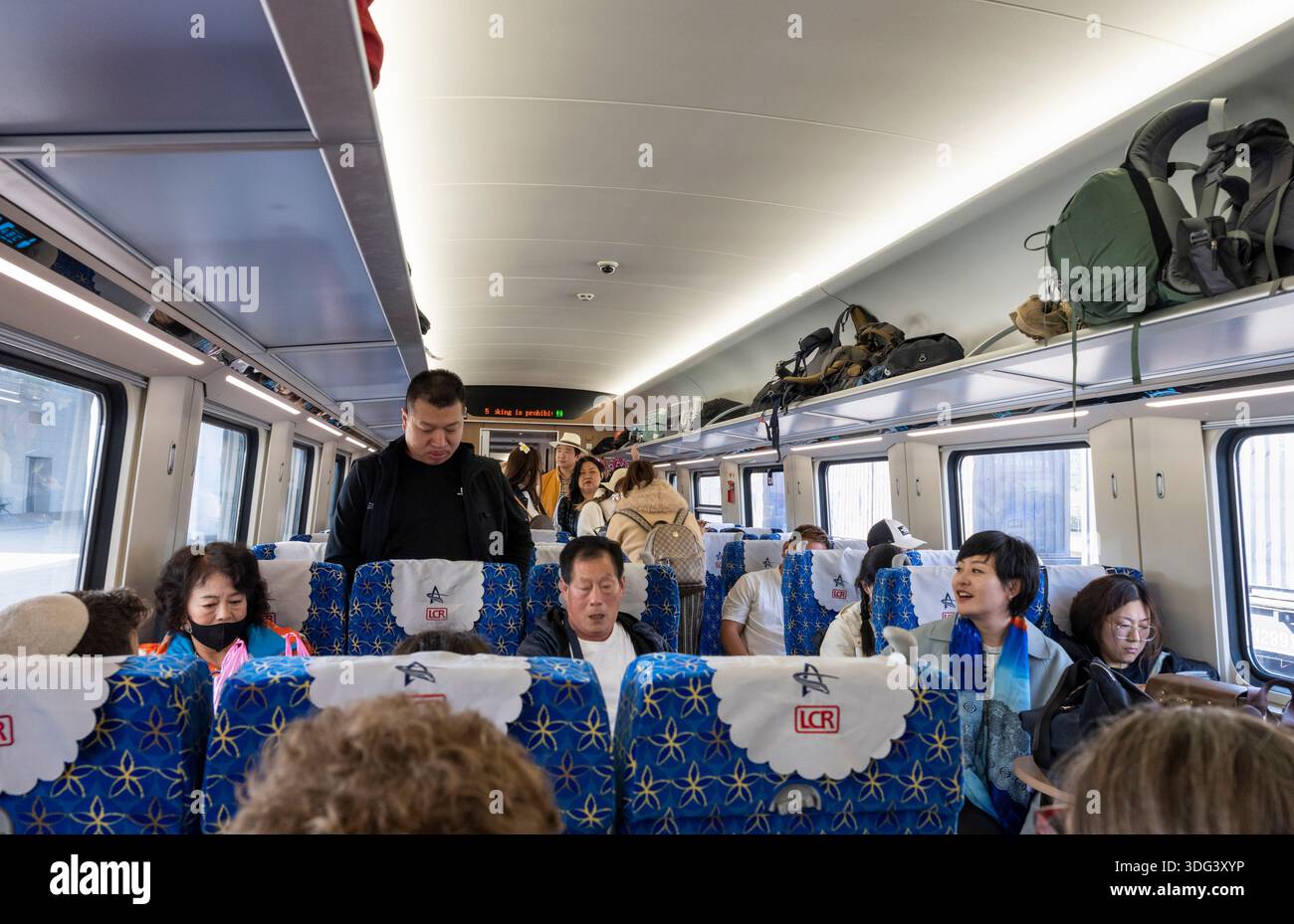 Laos-January 11 2026:Passengers aboard the high speed train sort their ...