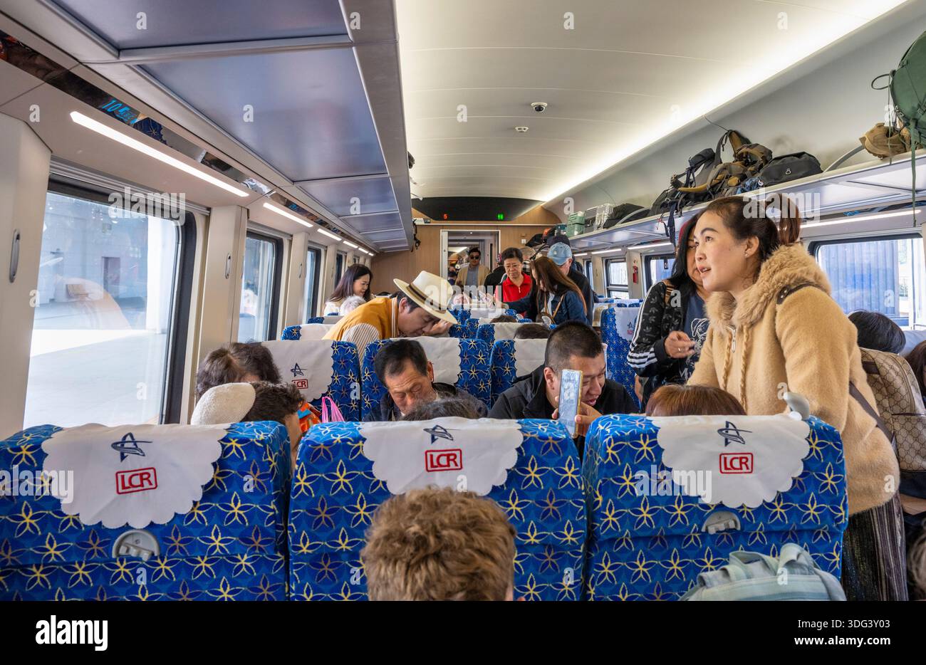 Laos-January 11 2026:Passengers aboard the high speed train sort their ...