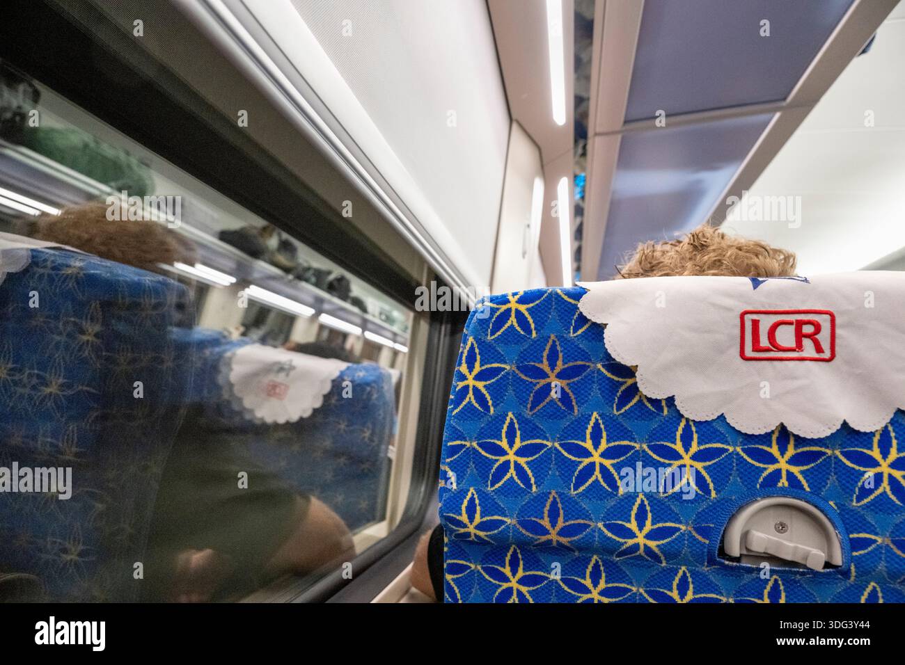 Laos-January 11 2026:Passengers aboard the high speed train relax as it ...