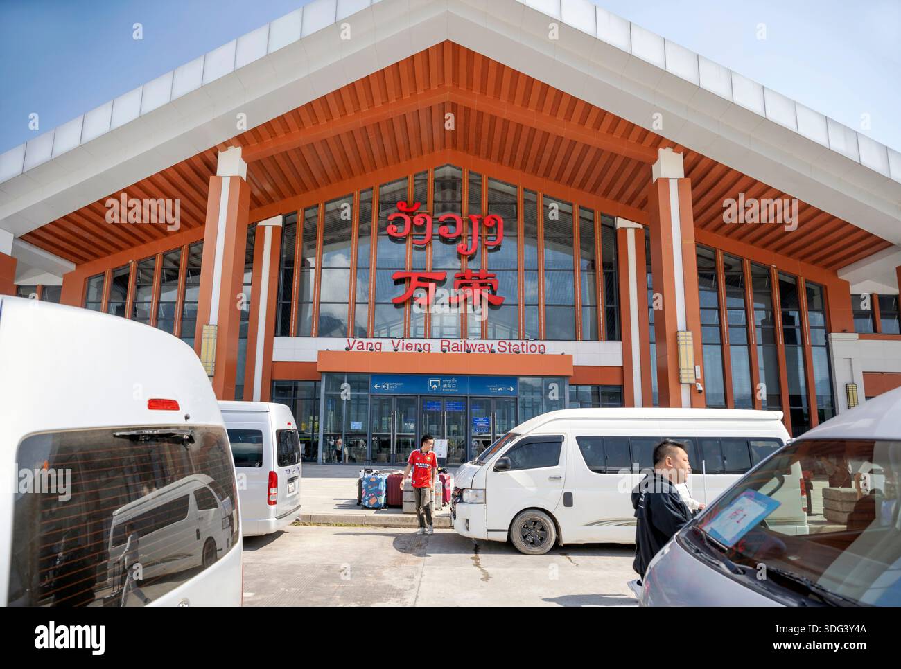 Laos-January 11 2026:White minivans await arriving passengers,to ...