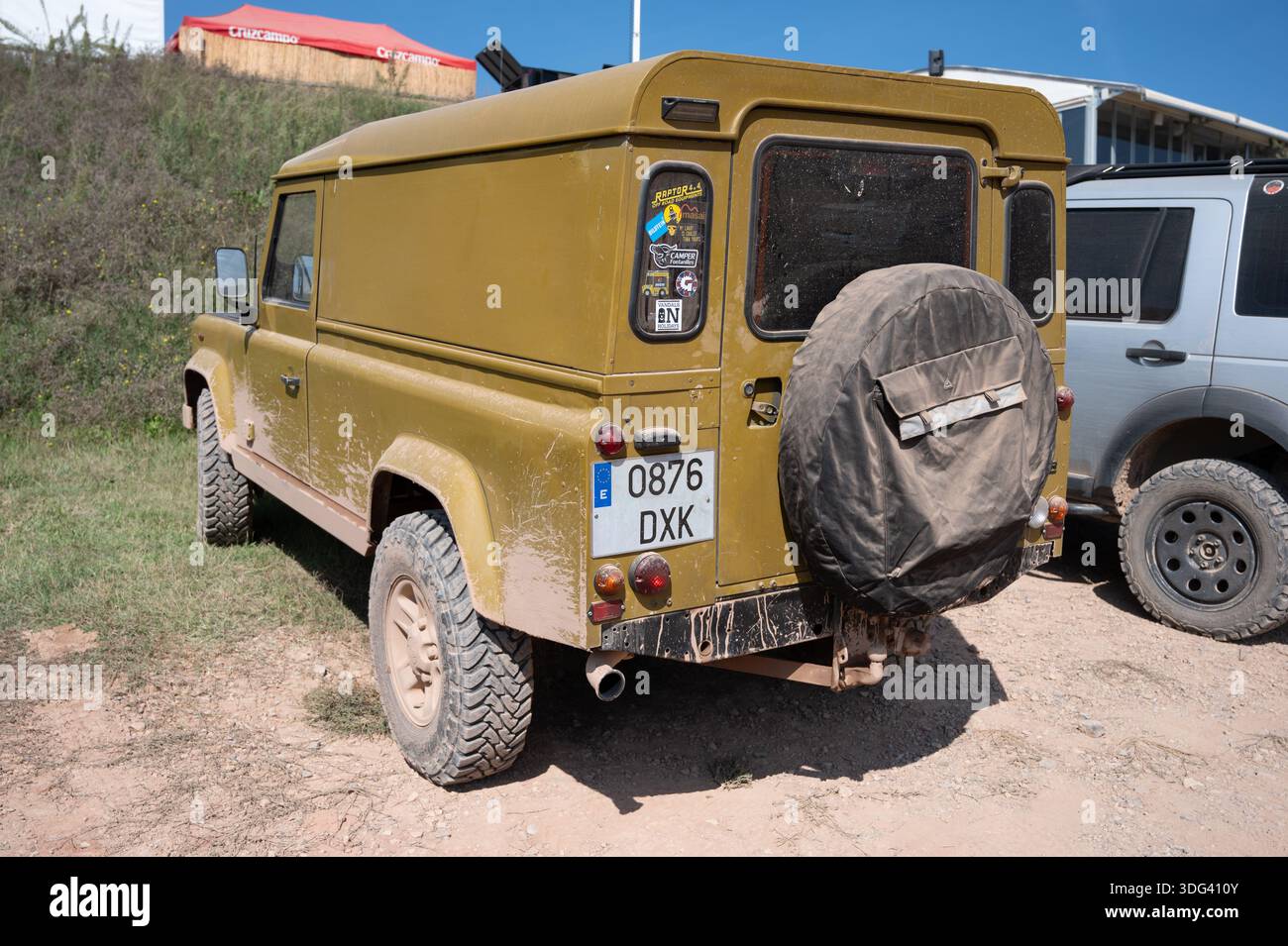 Rear view of a classic muddy mustard Land Rover Santana Series III long ...