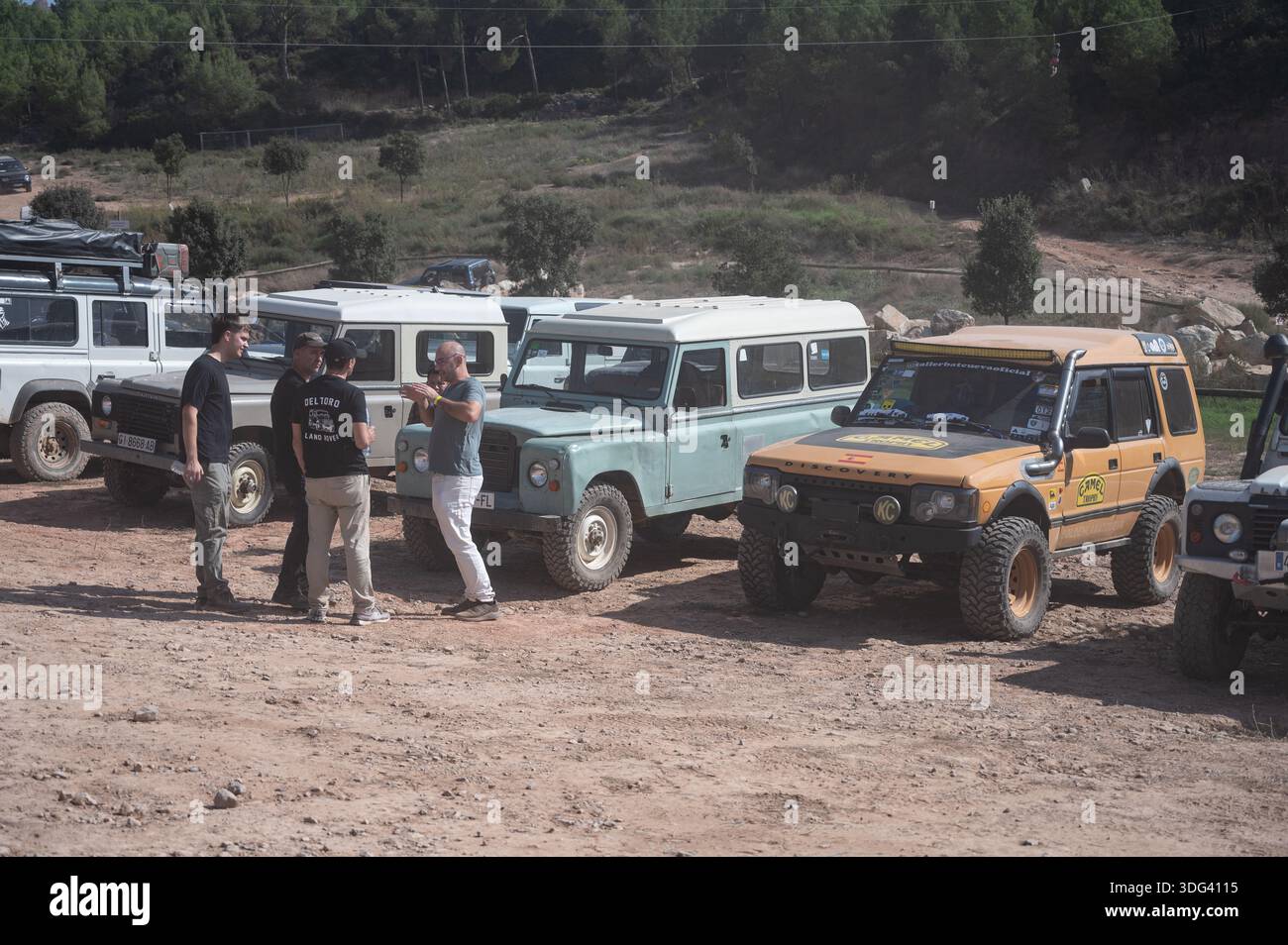 Off-road enthusiasts talking next to their vintage Land Rover Series ...