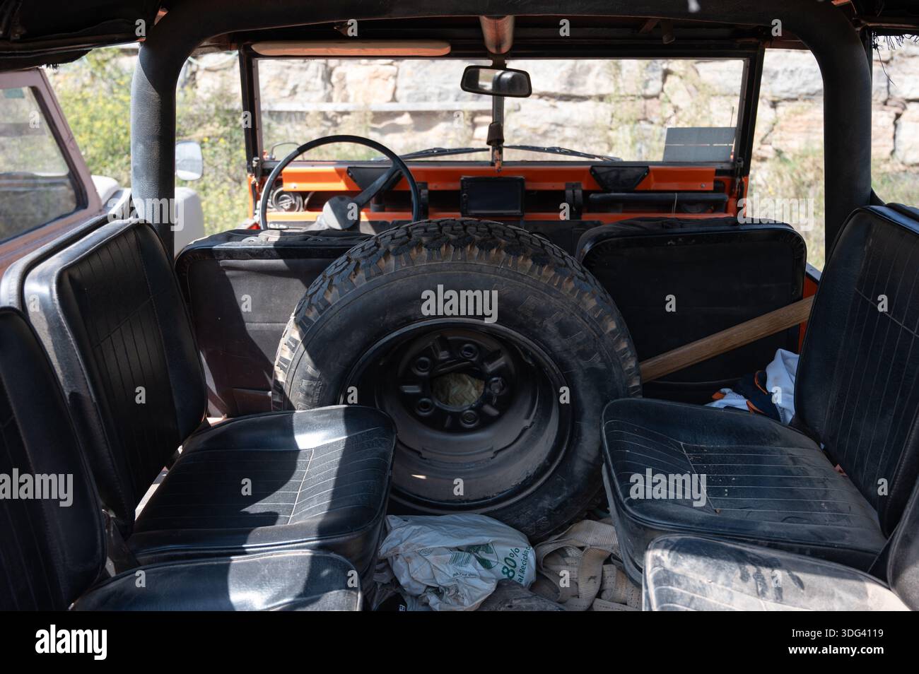 Interior view of a vintage orange Land Rover Santana Ligero 4x4 featuring original black leather ...