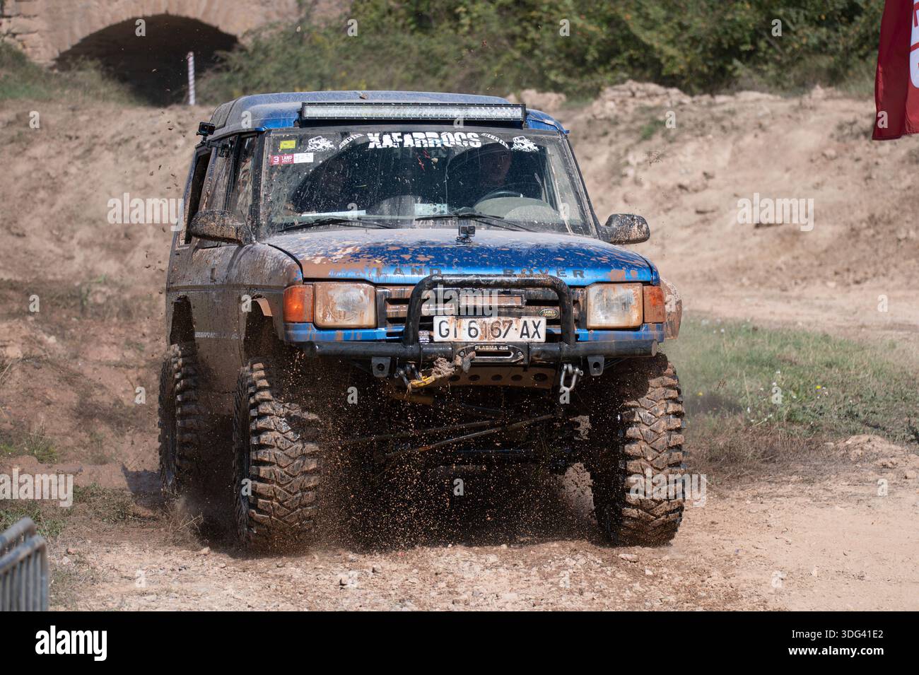 Modified blue Land Rover Discovery Series I splashing through mud. High ...
