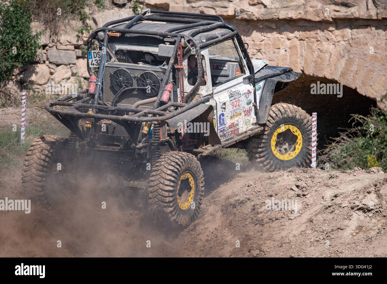 Modified green Land Rover Defender pickup climbing a steep hill ...