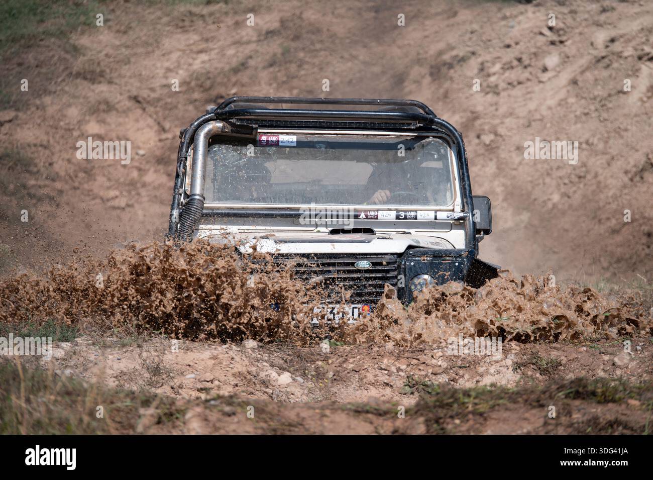 Modified Land Rover Defender plunging into a deep water obstacle ...