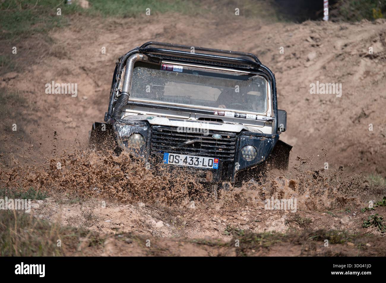 Modified Land Rover Defender plunging into a deep water obstacle ...