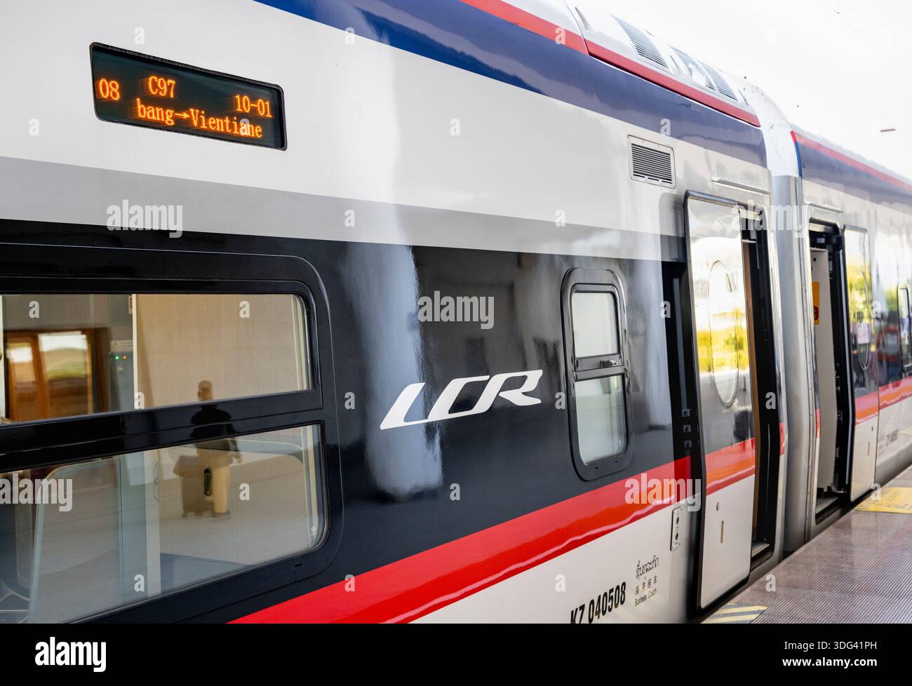 Laos-January 11 2026:Passengers board a high speed modern train,as it ...
