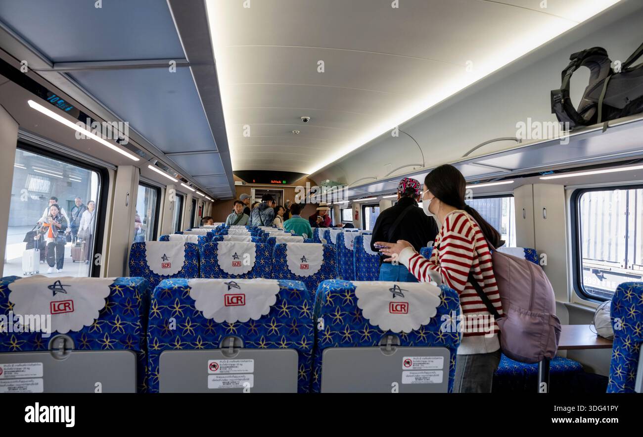 Laos-January 11 2026:Passengers aboard the high speed train sort their ...