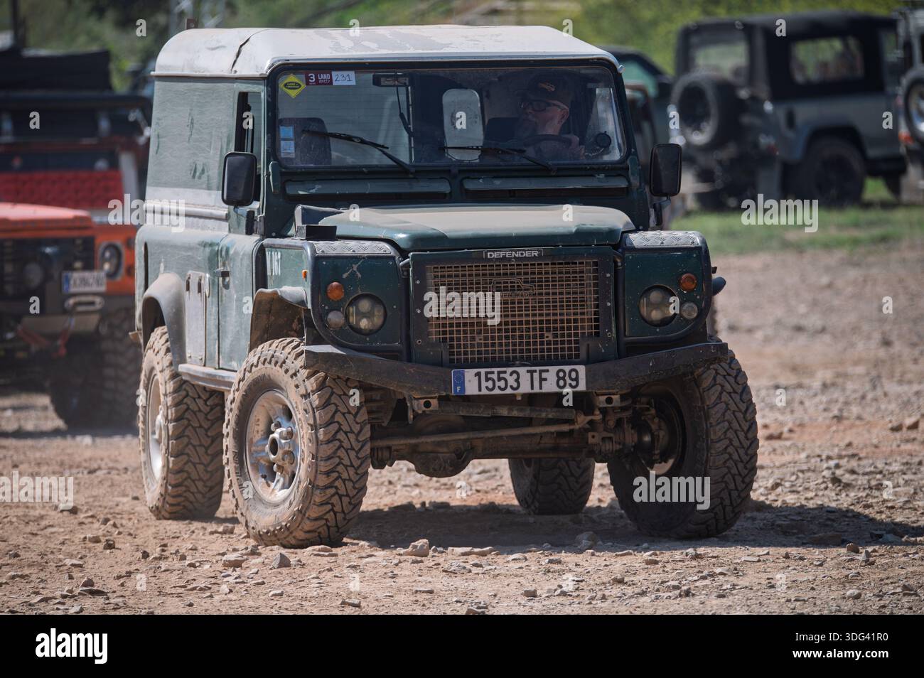 Front view of a modified green Land Rover Defender 110. Classic British ...