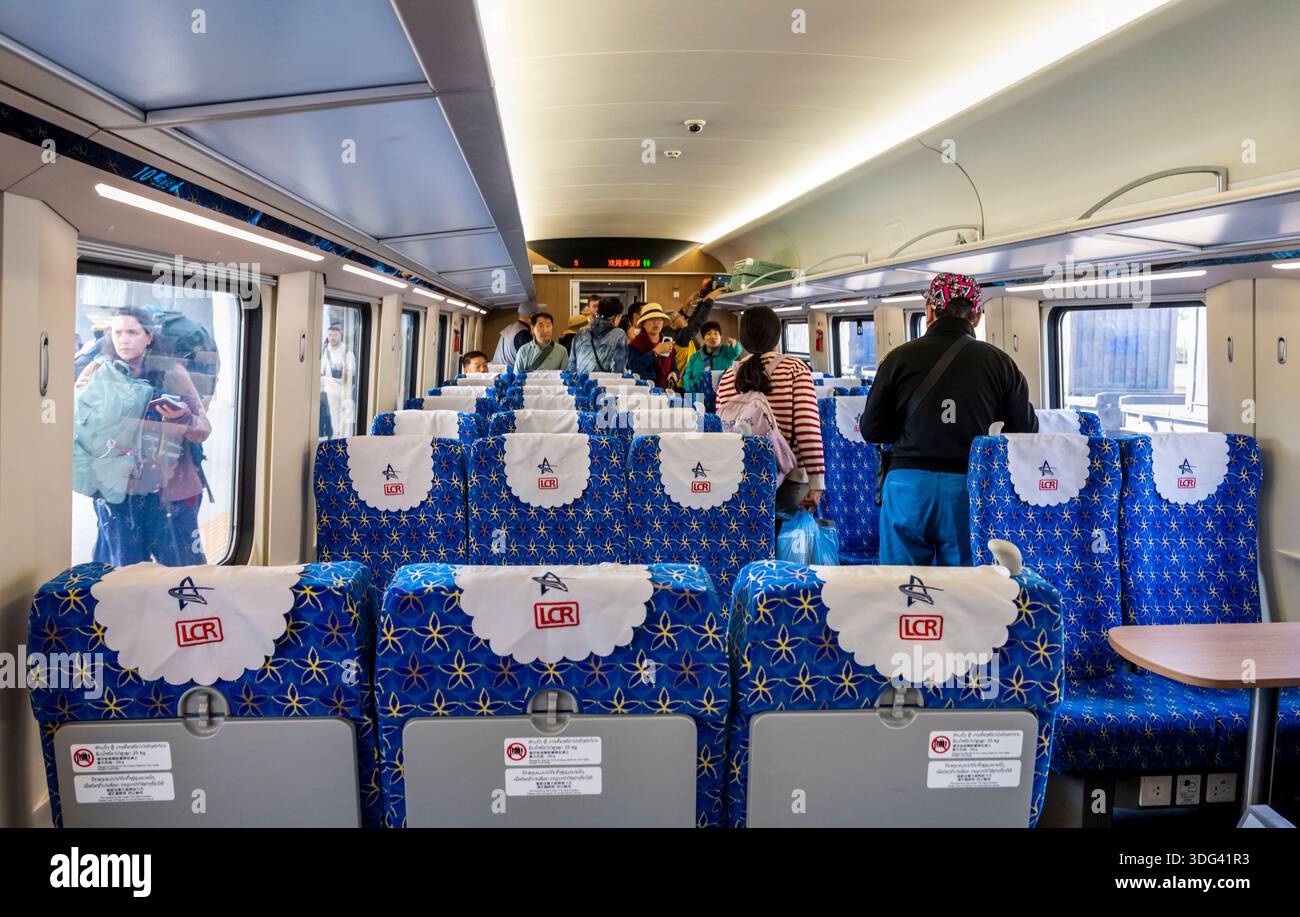 Laos-January 11 2026:Passengers aboard the high speed train sort their ...
