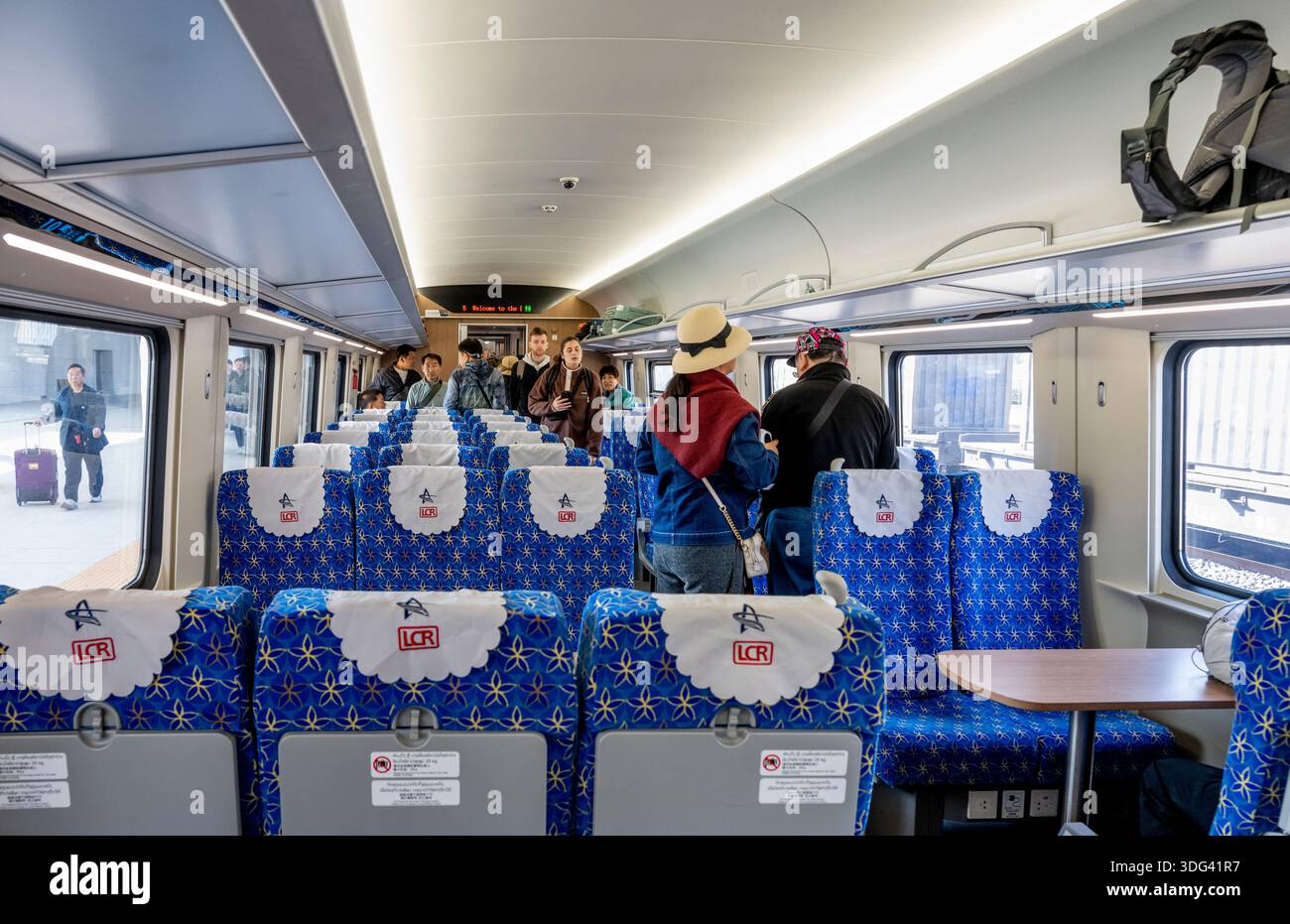 Laos-January 11 2026:Passengers aboard the high speed train sort their ...