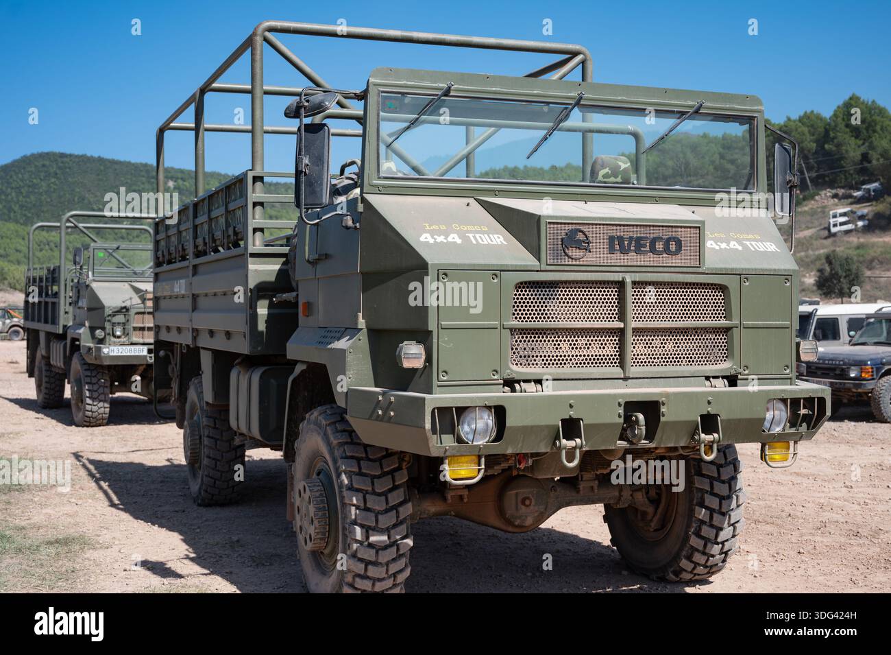 Front view of a military convoy featuring olive green Pegaso Iveco 7217 ...