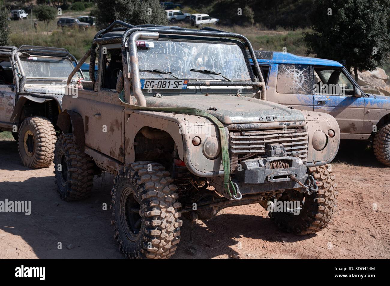 muddy green modified Land Rover Defender pickup. Features an external ...
