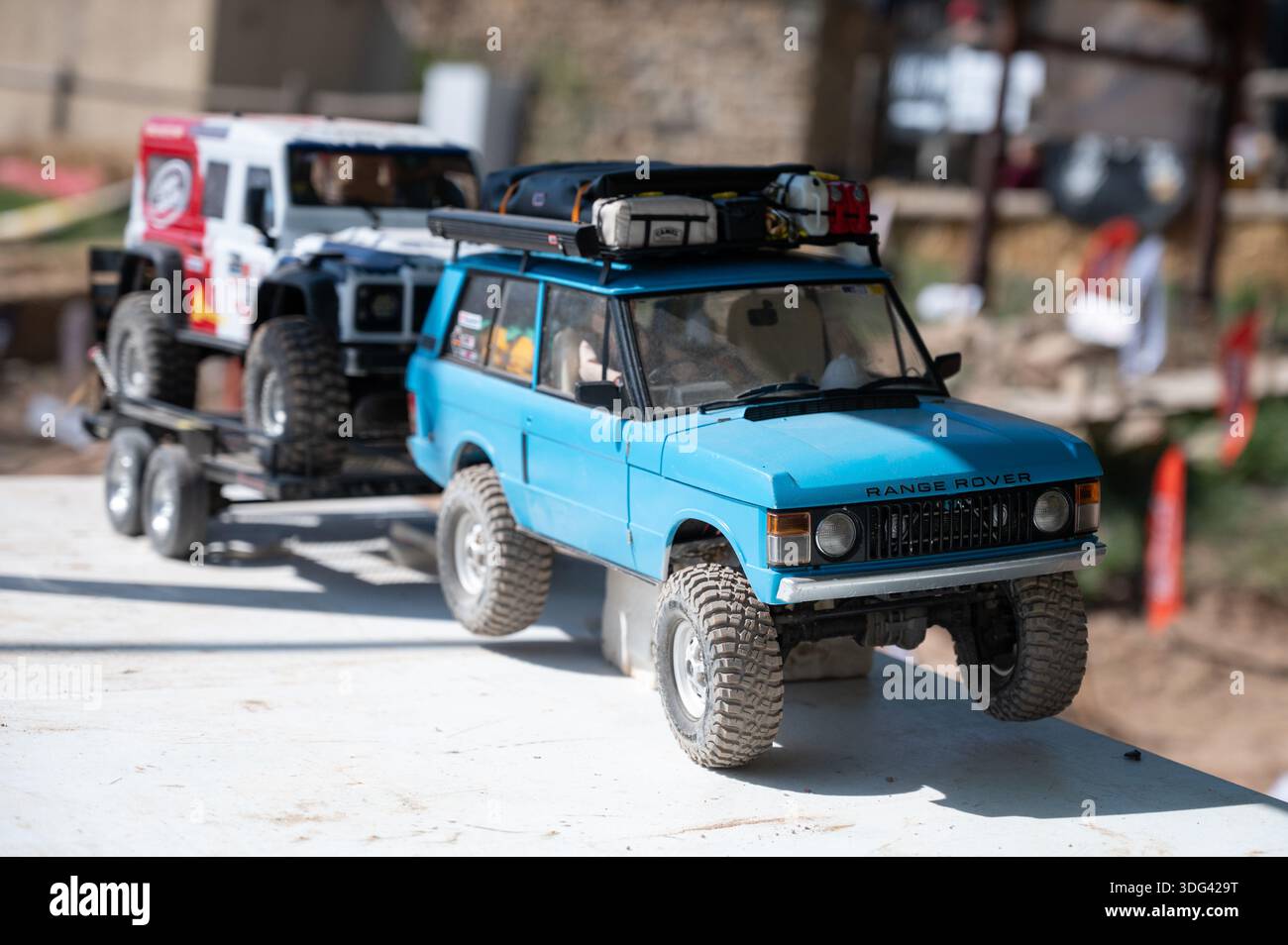 Detailed shot of a blue radio-controlled Range Rover Classic towing a ...