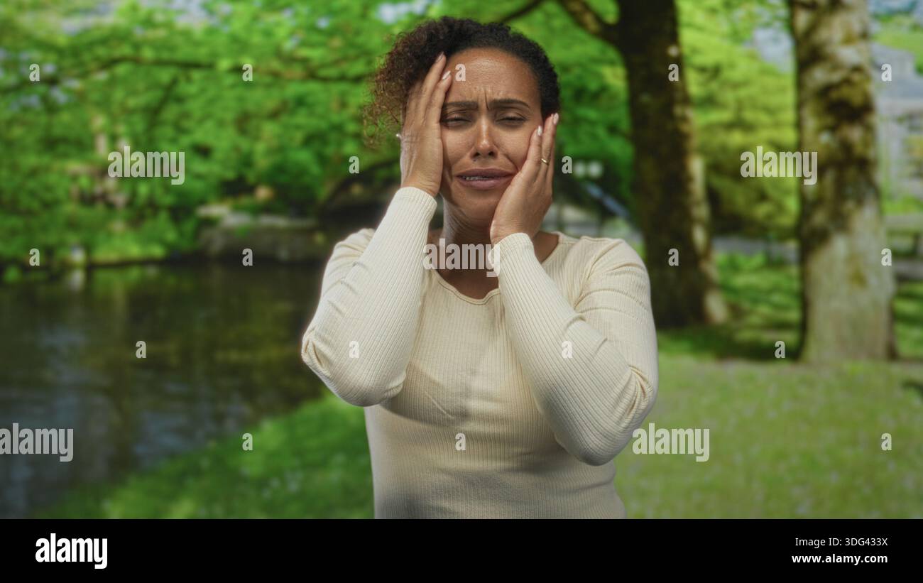 Woman pressing hands cheeks crying hi-res stock photography and images - Alamy