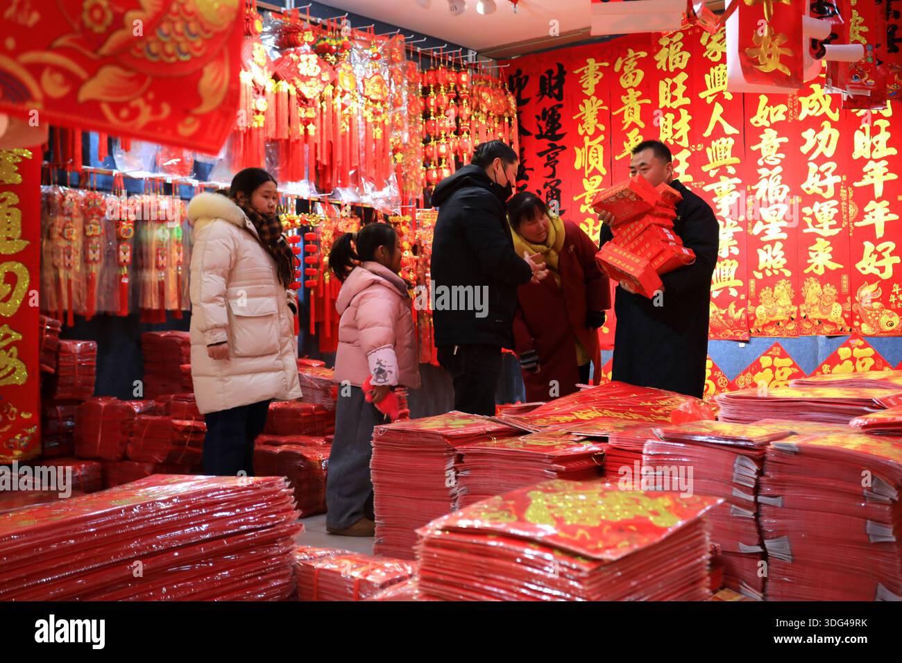 Residents shop for festive decorations at a commodity market in Huai'an ...