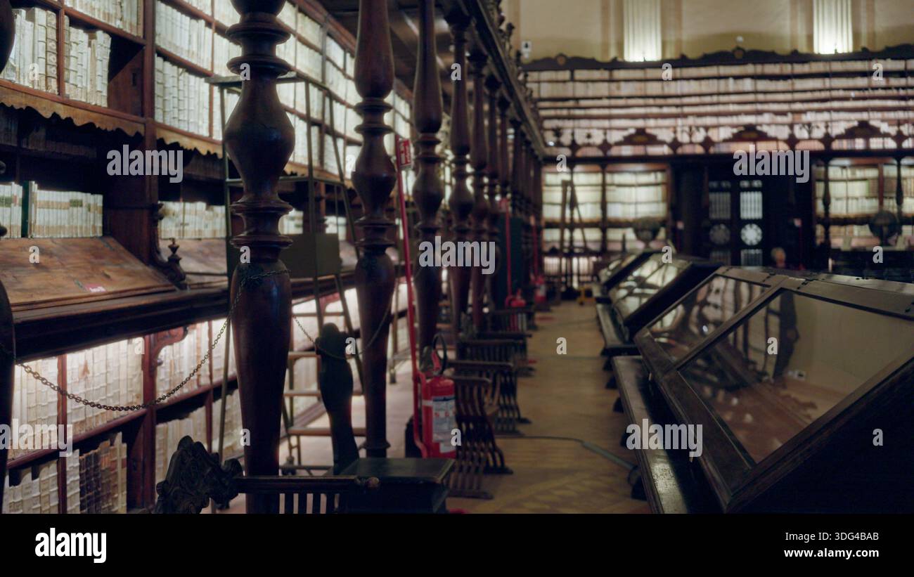 Historic library interior with shallow focus, wooden stacks and display ...
