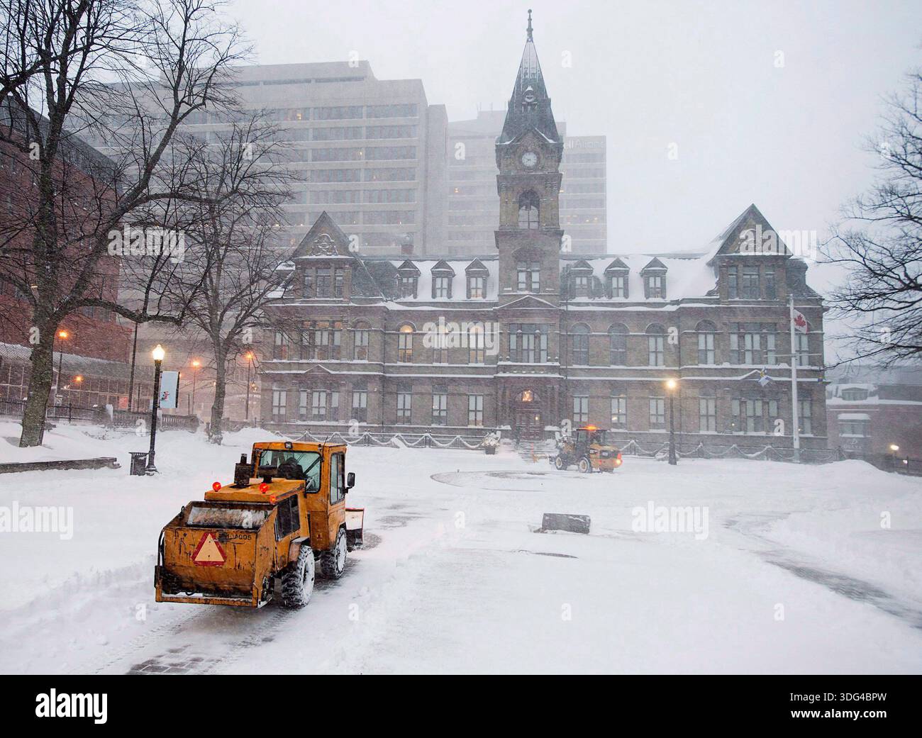 Workers clear snow at city hall in Halifax on Tuesday, Jan. 30, 2018 ...