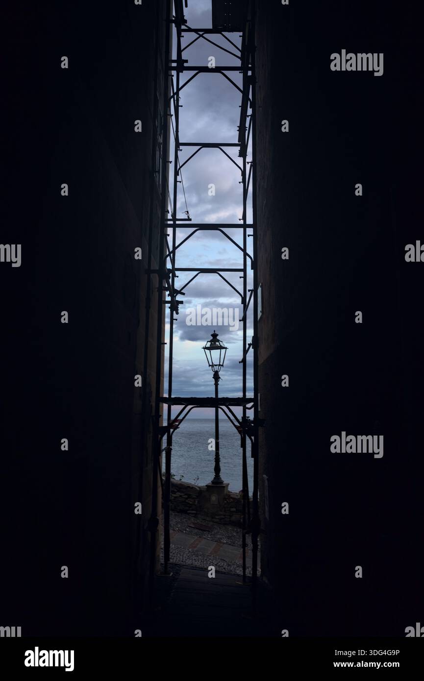 Narrow alley between tall buildings with a scaffolding hindering the ...