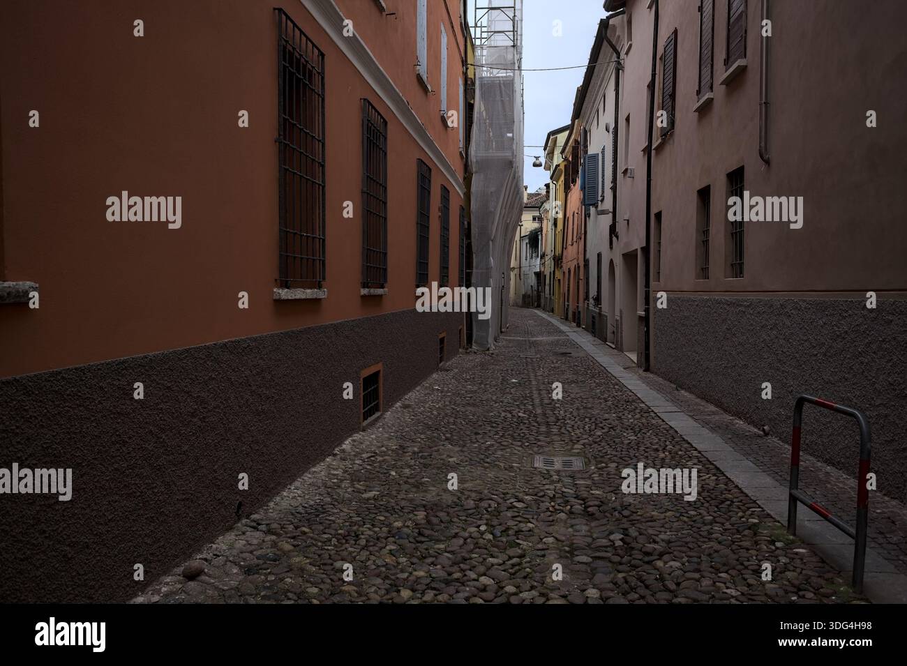 Cobbled alley partly in the shade with a scaffolding on a facade Stock ...