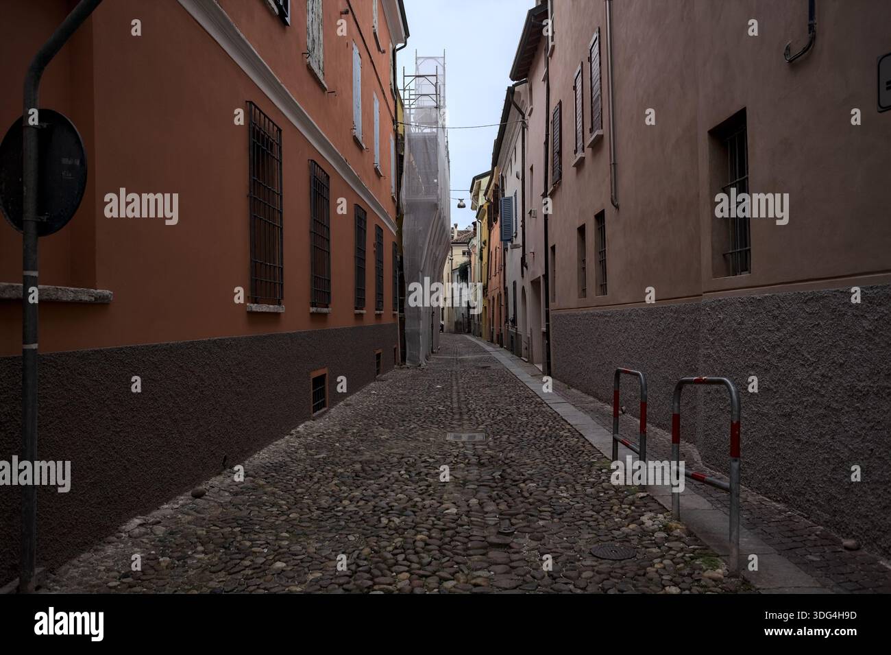Cobbled alley partly in the shade with a scaffolding on a facade Stock ...