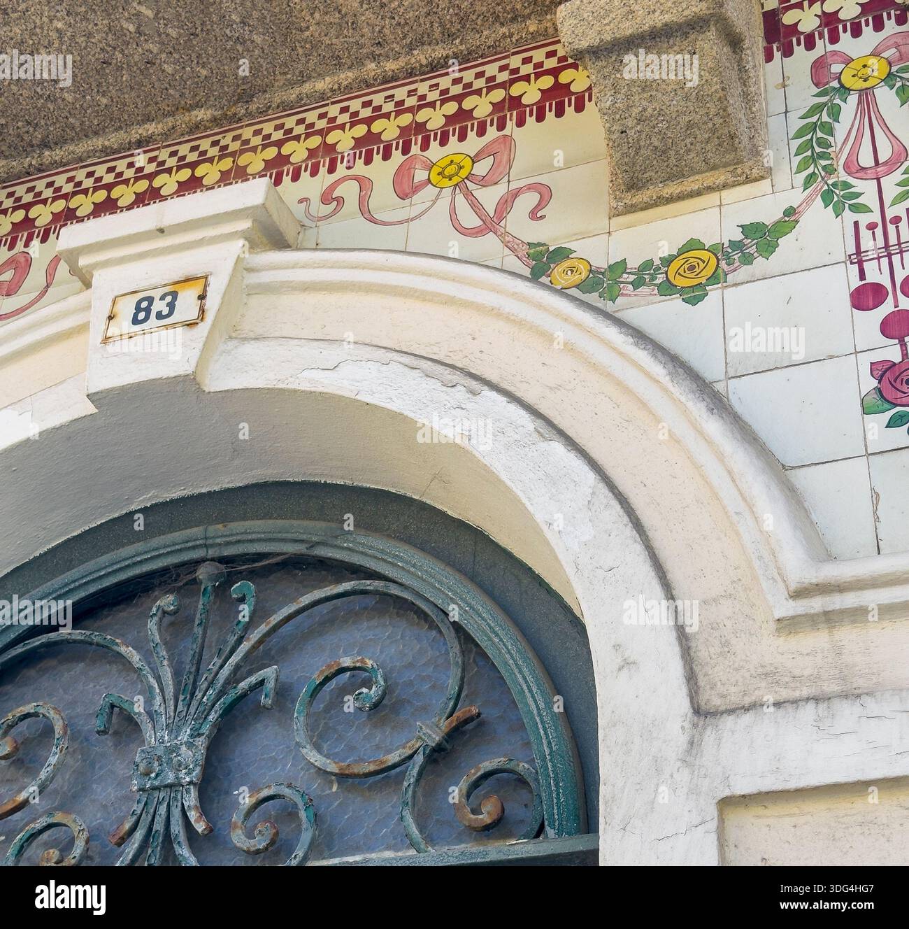 Architecture facade with arch and number 83, traditional ceramic ...