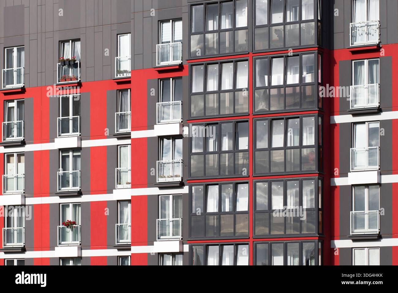 Close-up of modern residential building facade with red and gray panels ...