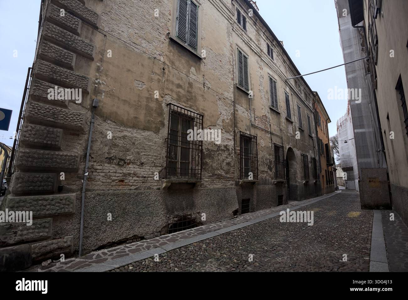 Worn out facade of a palace in a cobbled street in an italian town ...