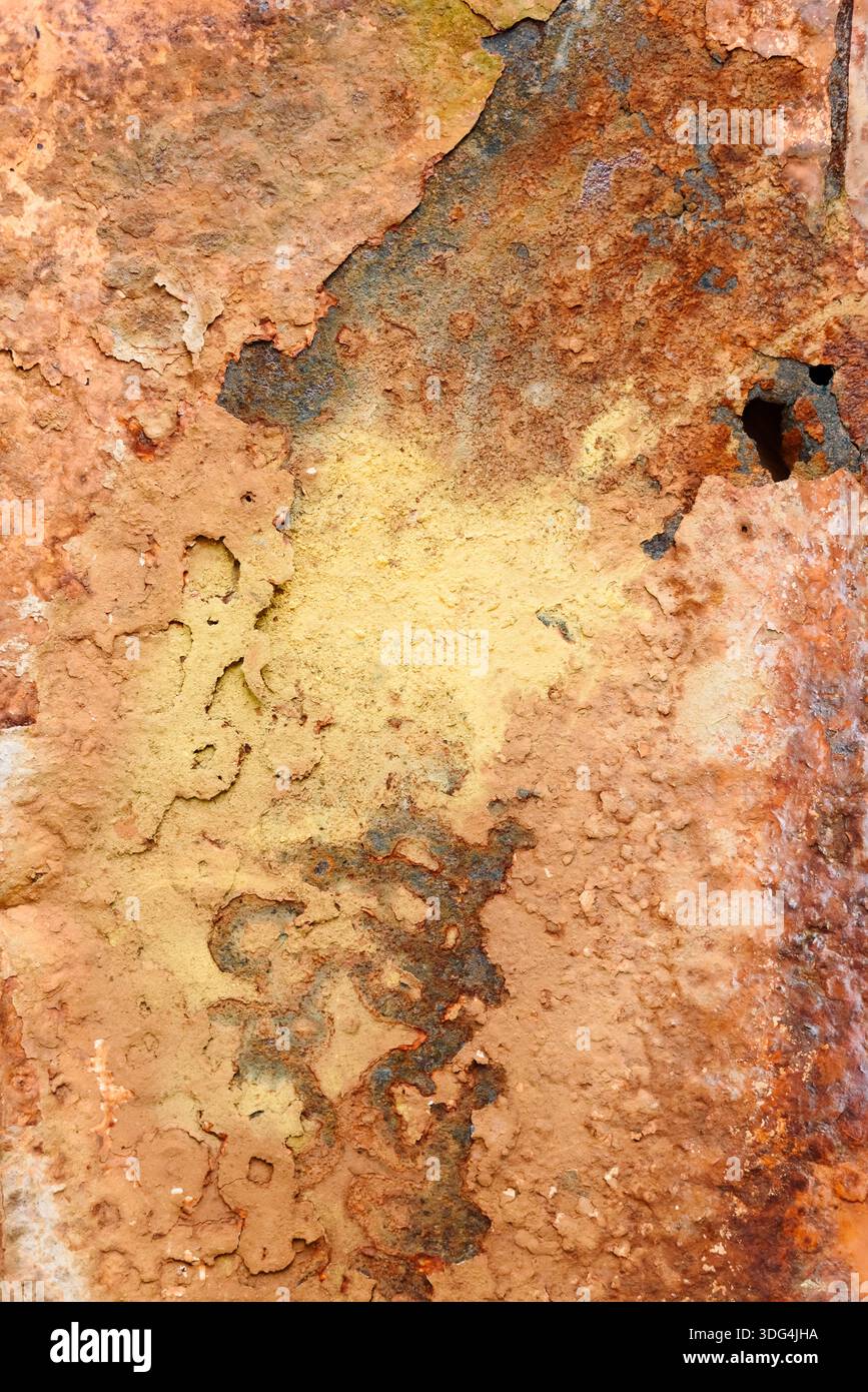 The close-up view shows rusty metal with peeling layers and an uneven ...