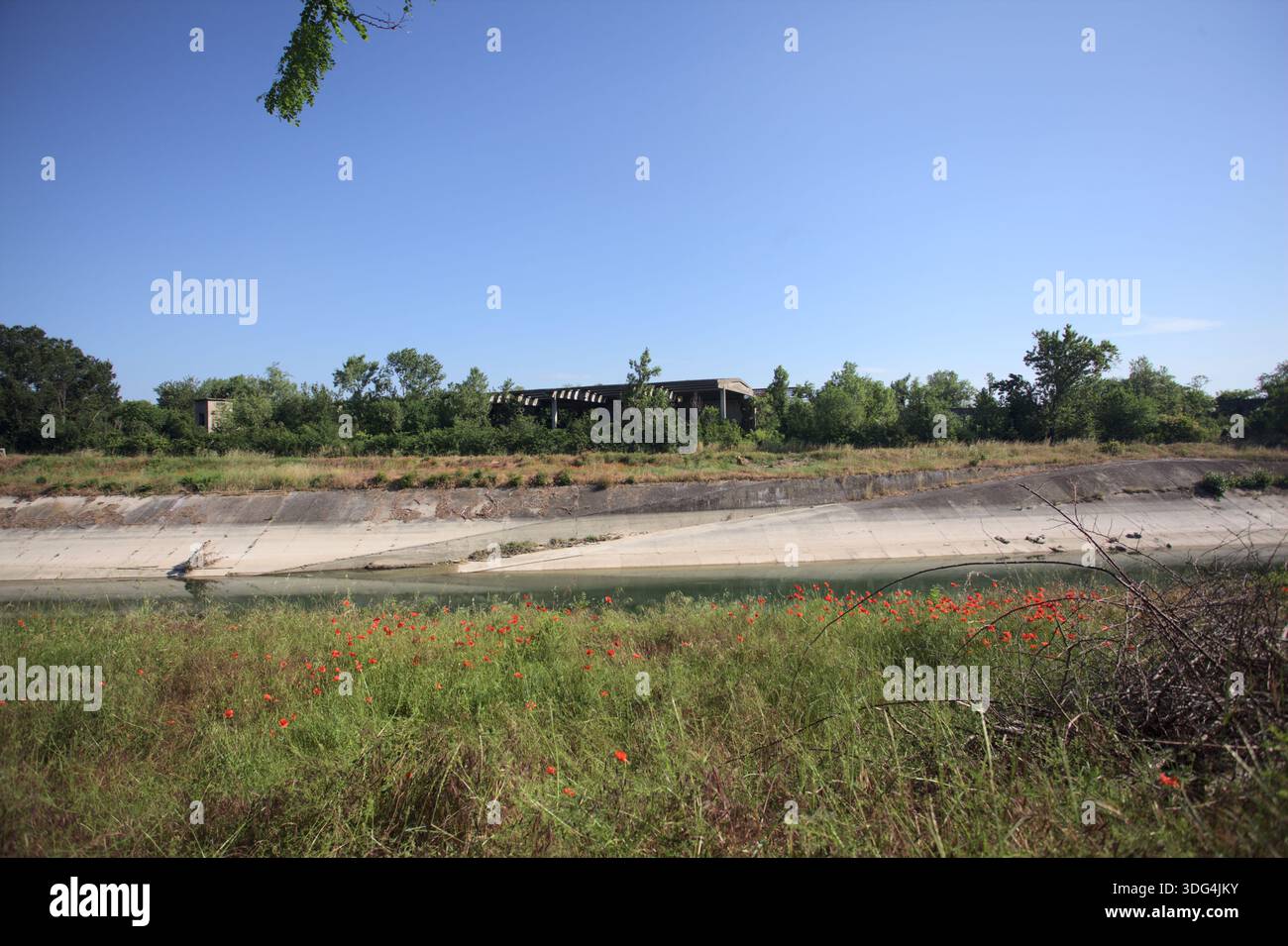 Bank of a diversionary channel in the italian countryside on a sunny ...