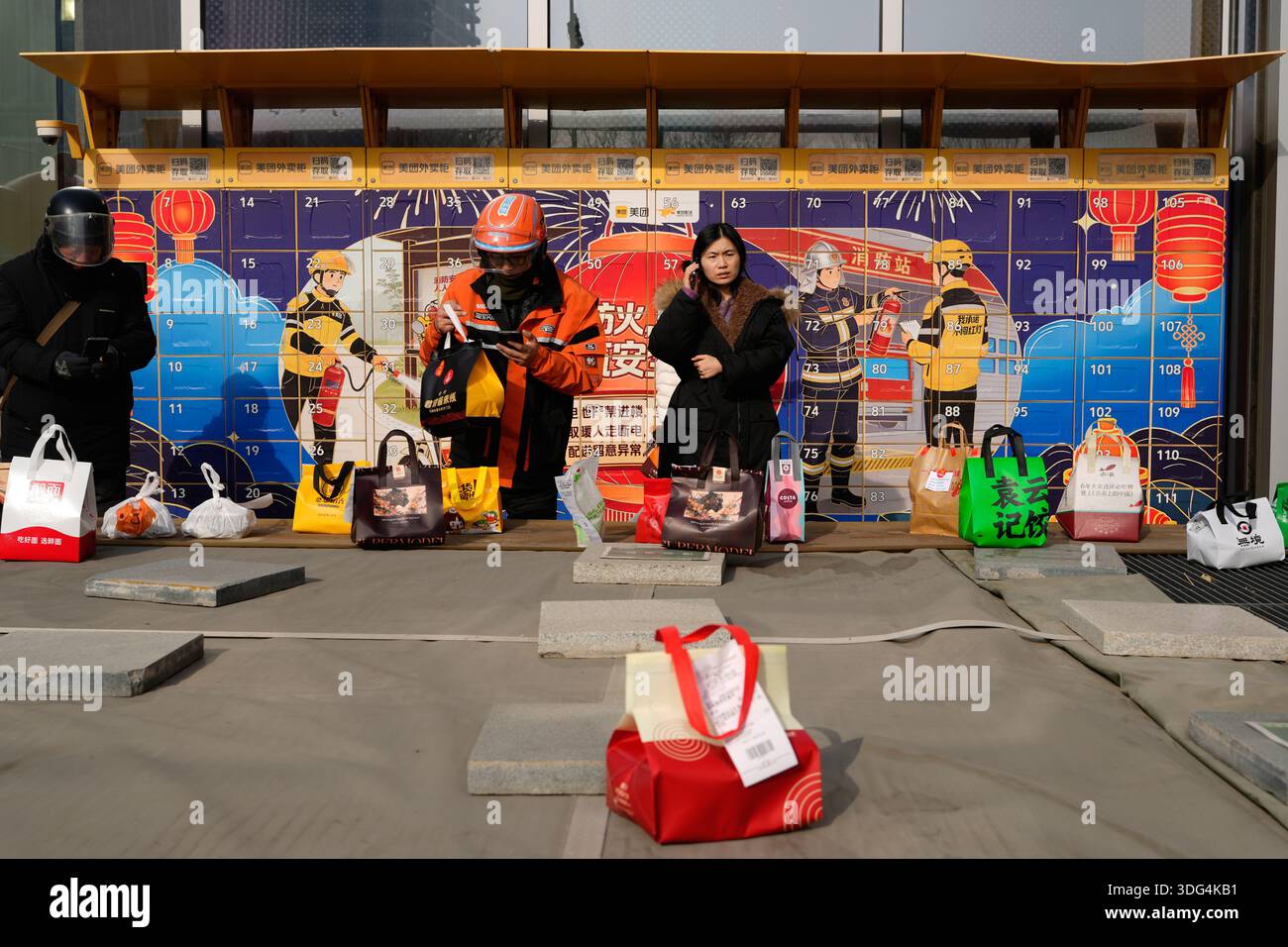 A woman makes a call near an area for delivery drivers to leave their ...