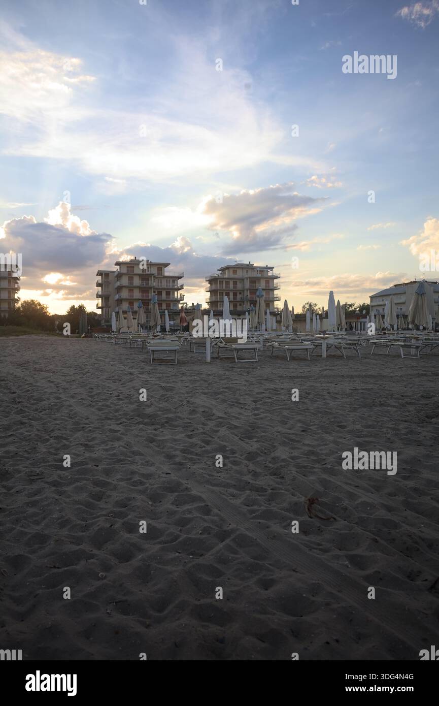 Buildings on an avenue next to a beach at sunset seen from behind an ...