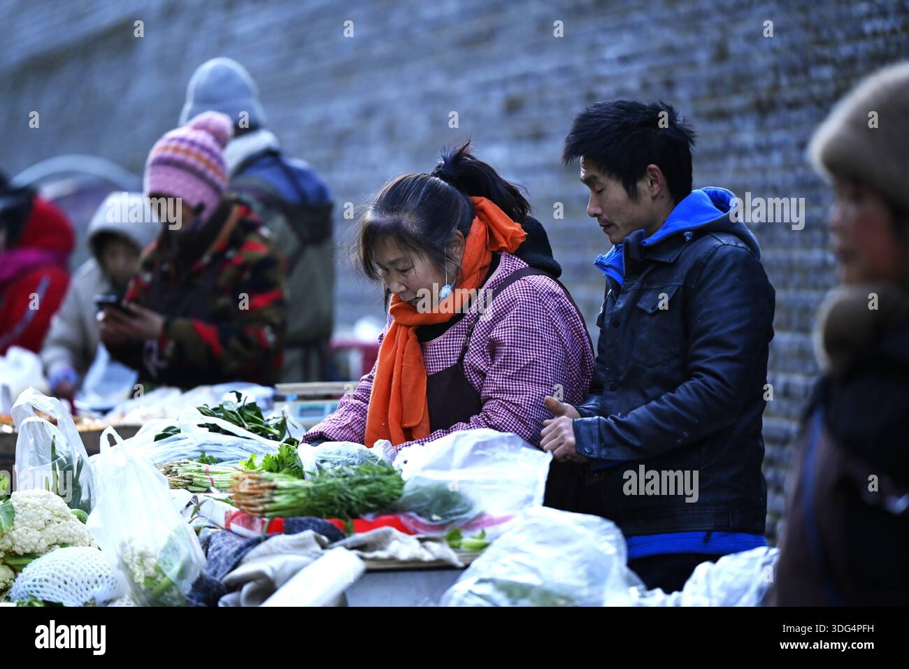 Vendors sell goods at Xiaonanmen morning market near the city wall in ...