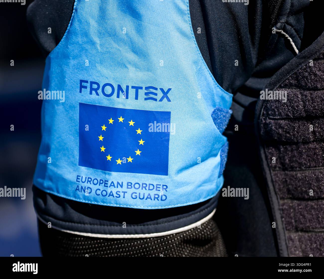FERES - The Frontex logo is displayed on a border guard at the Greek ...