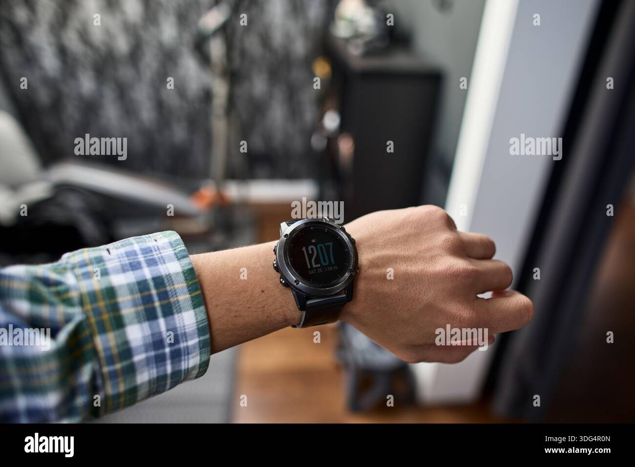Close-up view of a modern smartwatch worn on a human wrist. The device ...