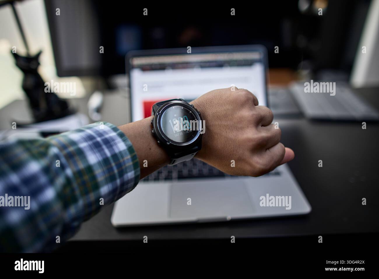 Close-up view of a modern smartwatch worn on a human wrist. The device ...