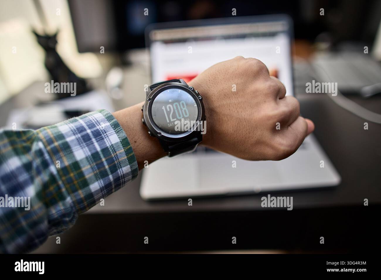 Close-up view of a modern smartwatch worn on a human wrist. The device ...