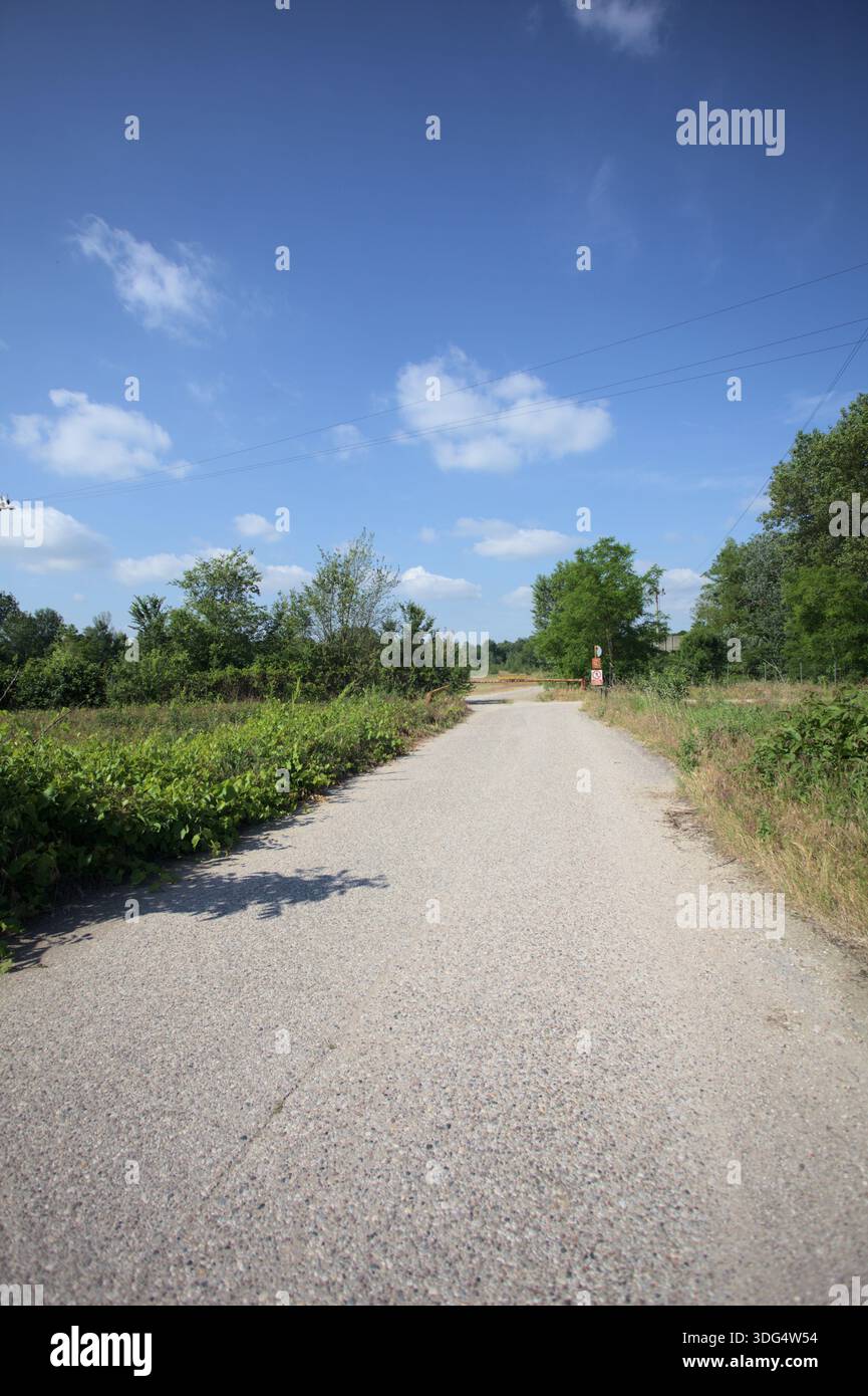Dirt road between fields with an overhead power line by its edge ...