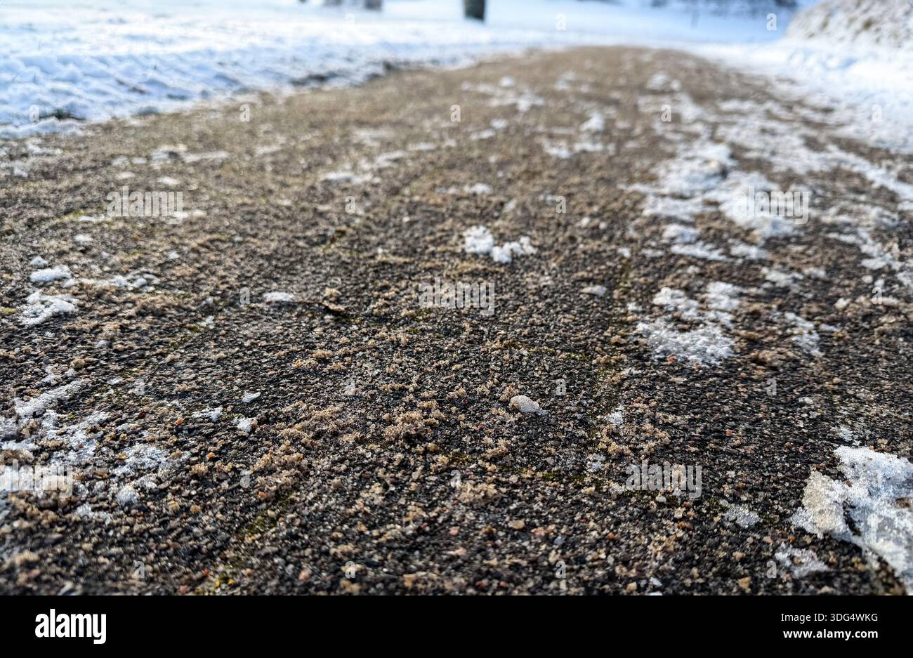Close up of pedestrian walk path with scattered sand to protect from ...