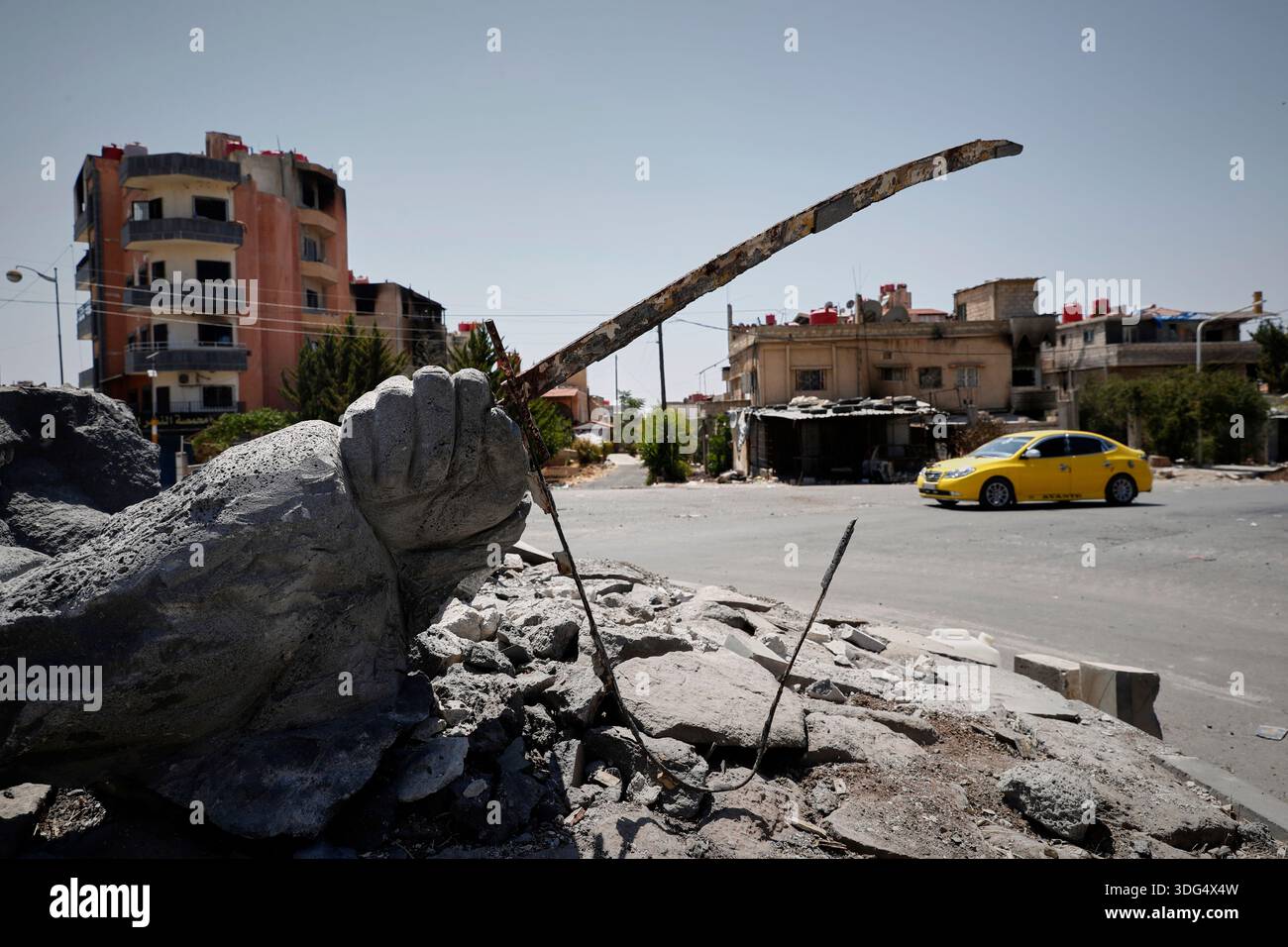FILE - A car drives by a destroyed statue in the Druze-majority town of ...