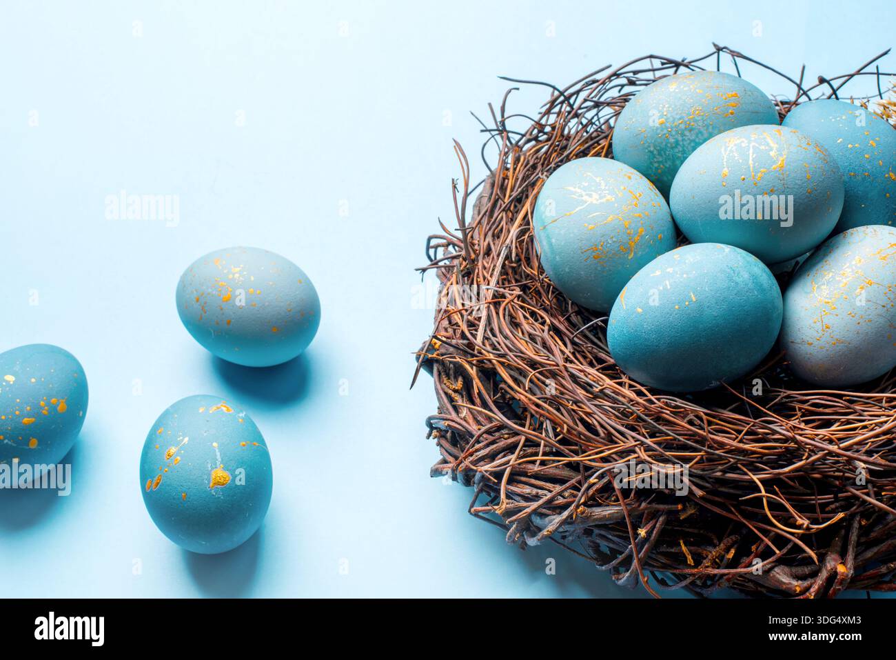 Nest with Easter eggs on a blue background. Flat lay, top view Stock ...
