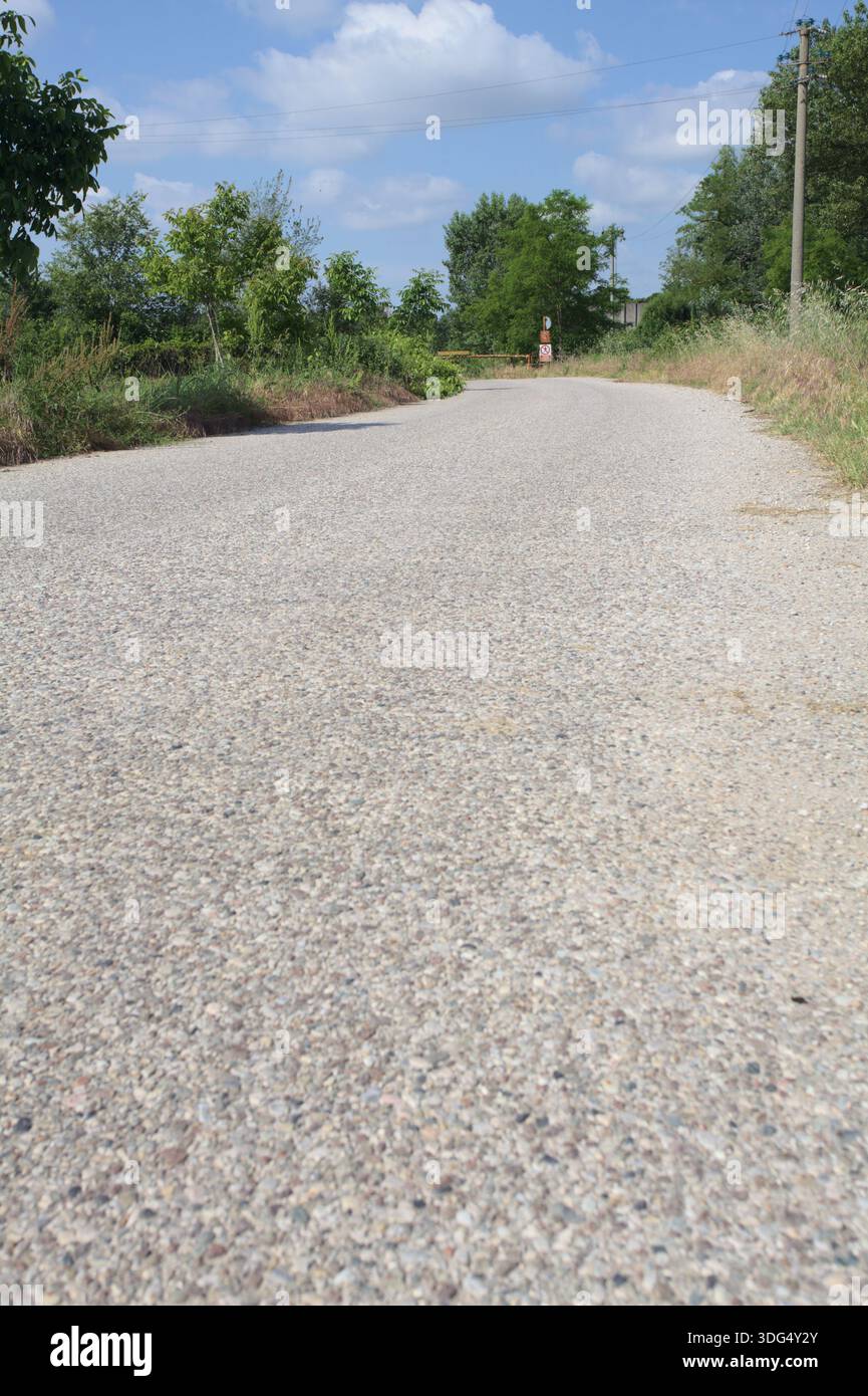 Dirt road between fields with an overhead power line by its edge ...