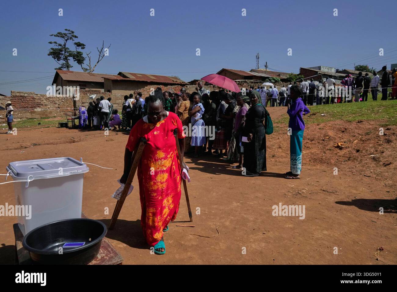 Voters line up to cast their ballots at a polling station, during the ...